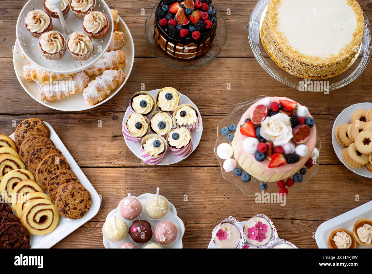 Table with cakes, cookies, cupcakes, tarts and cakepops Stock Photo - Alamy