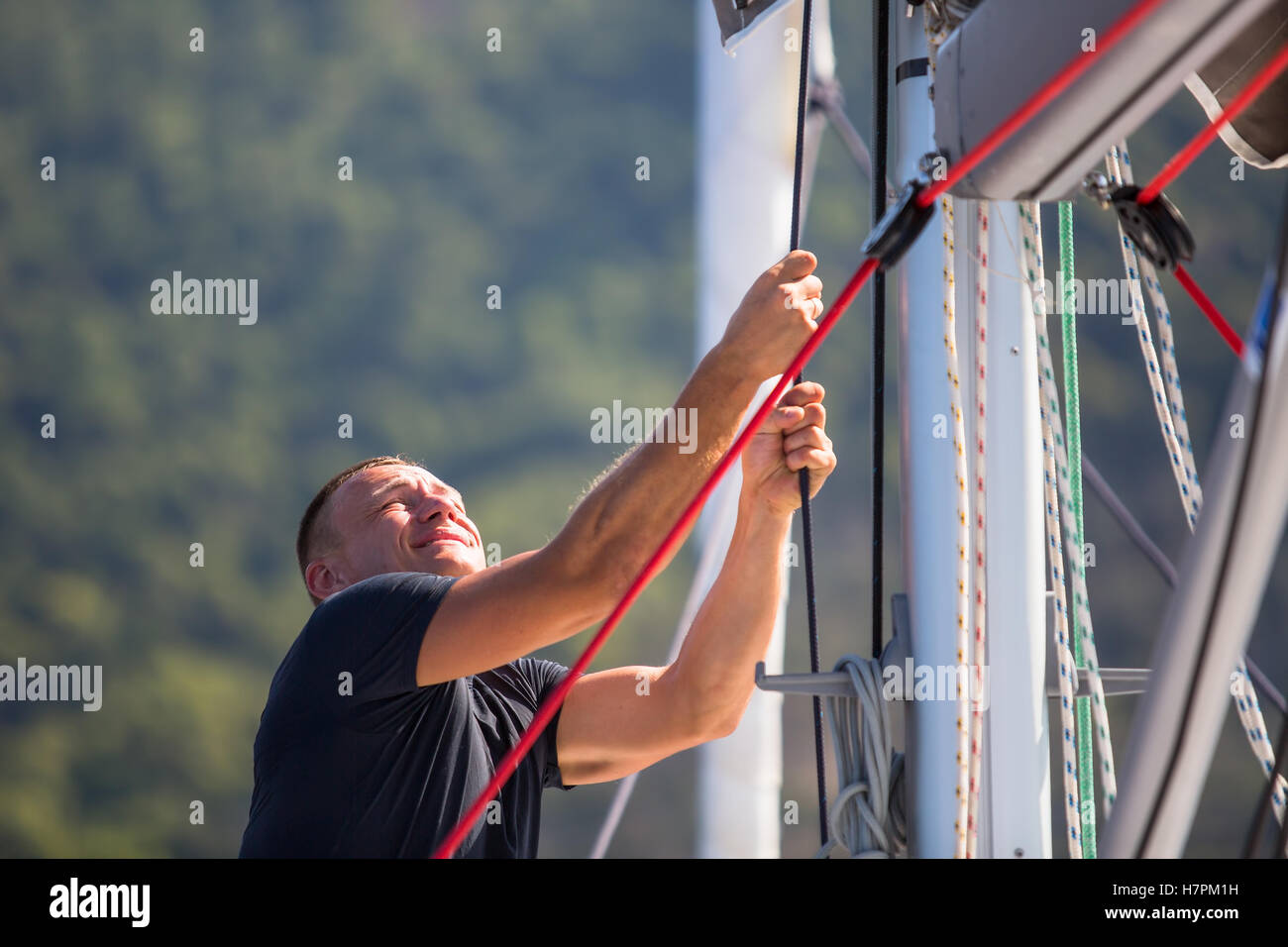 Sailing, man pulling ropes. Luxery yacht boat Stock Photo - Alamy