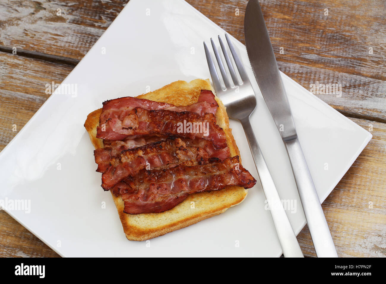 Breakfast consisting of crispy bacon on toast Stock Photo - Alamy