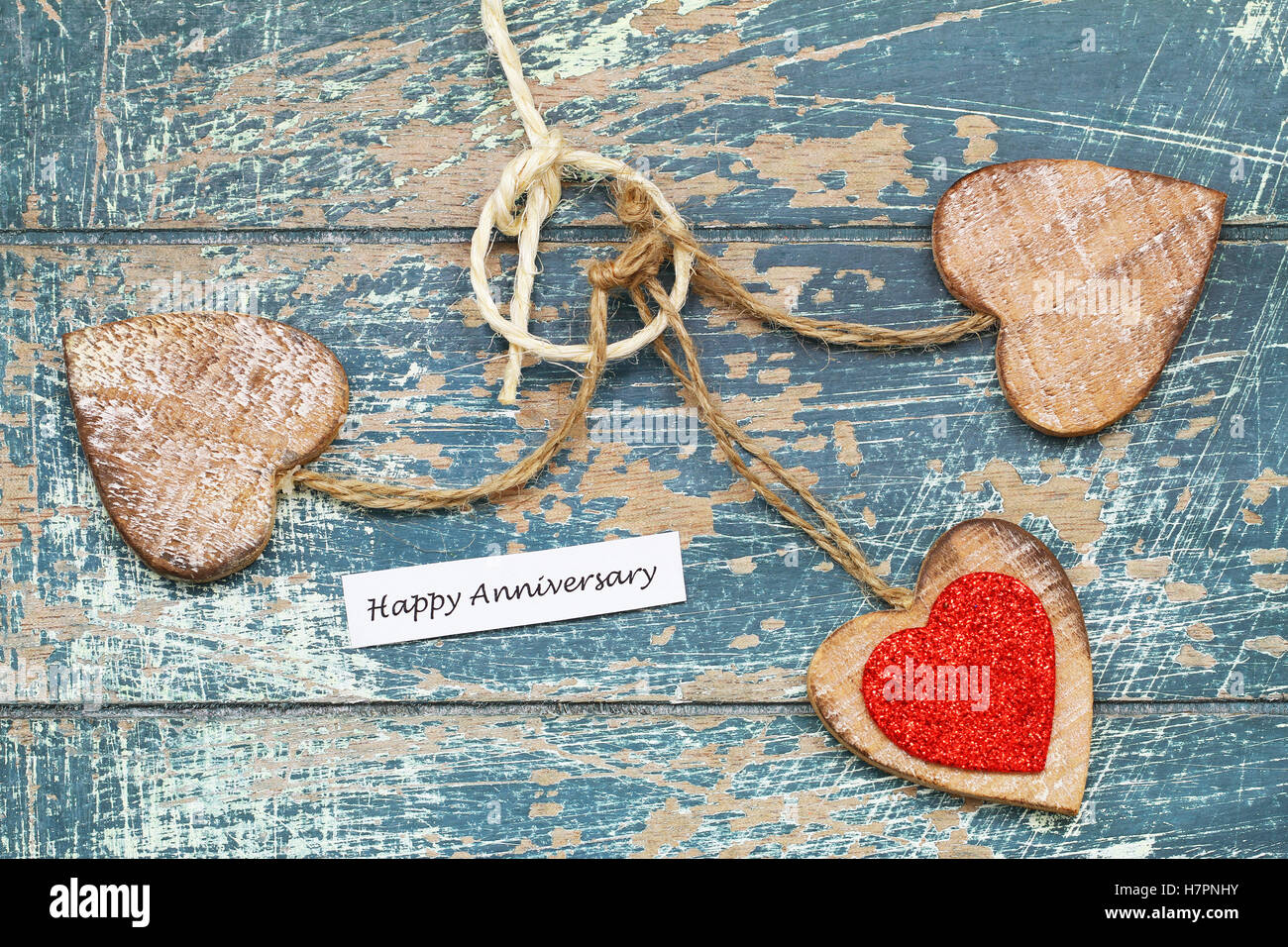 Happy Anniversary card with wooden hearts on rustic surface Stock Photo ...