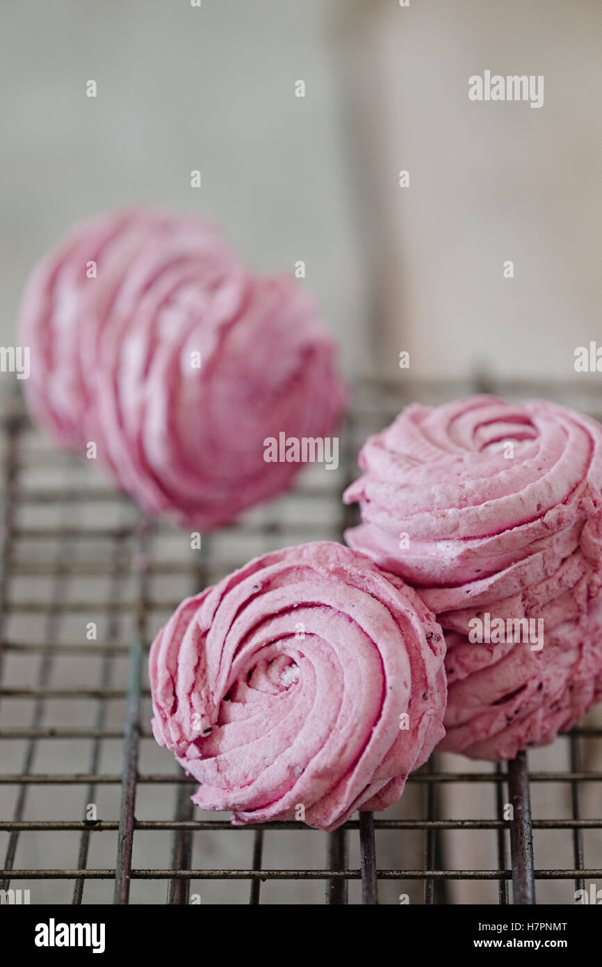 Homemade sweet pink marshmallows - zefir on a baking rack. Wooden ...