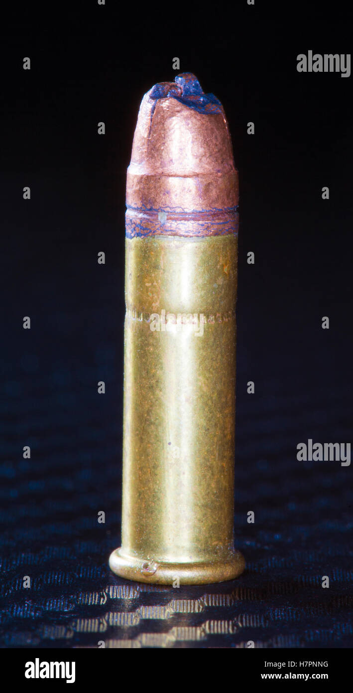 Lead bullet on a rimfire cartridge that has been damaged Stock Photo ...