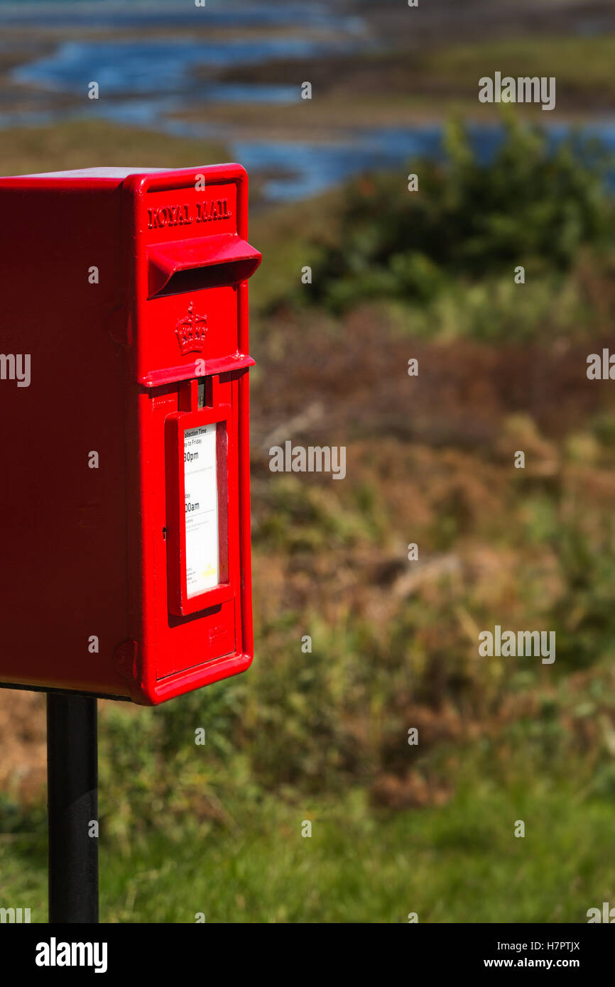 Red post letter box on countryside, rural environment, fields and ...