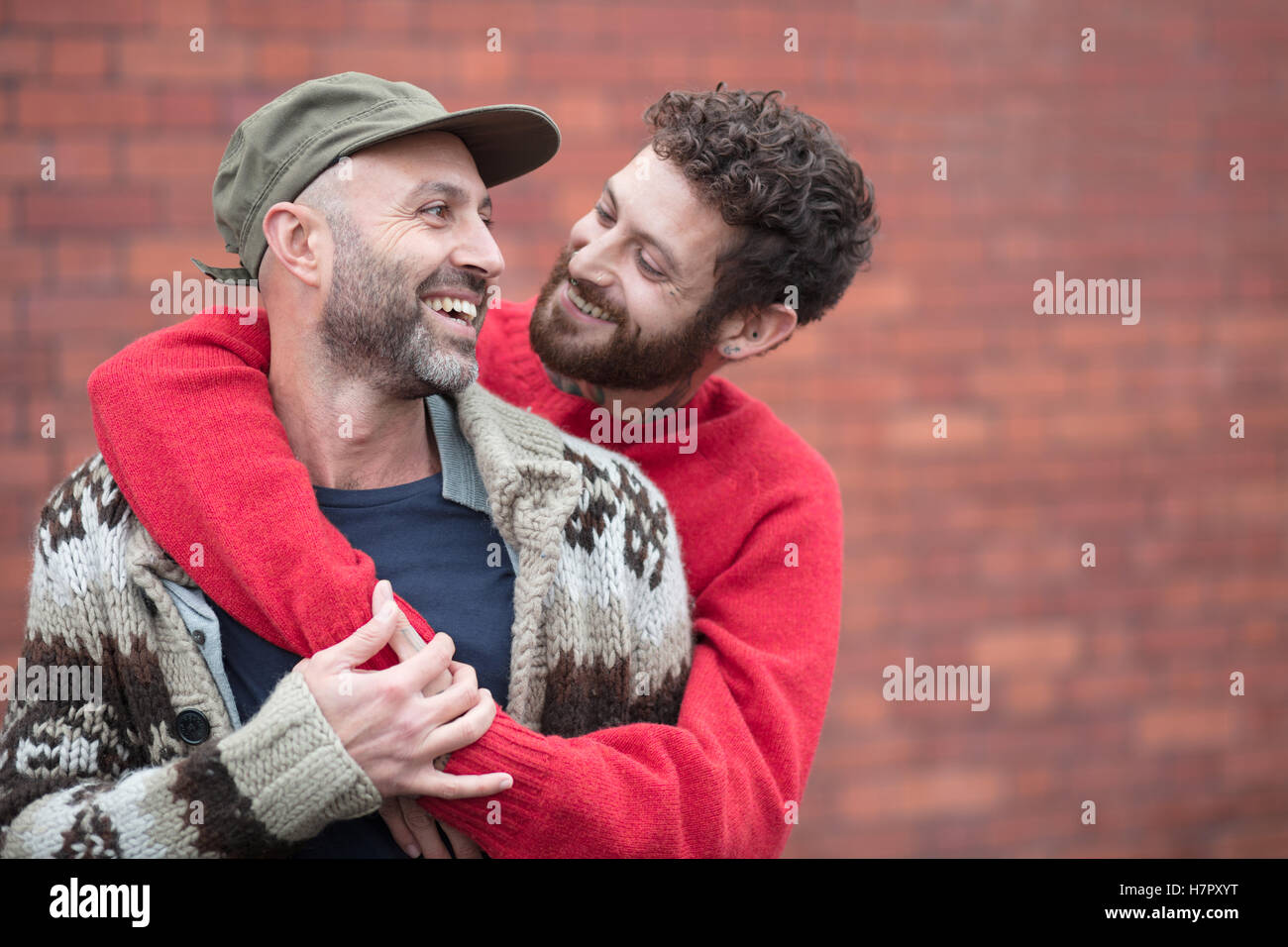 Happy gay couple cuddling hi-res stock photography and images - Alamy