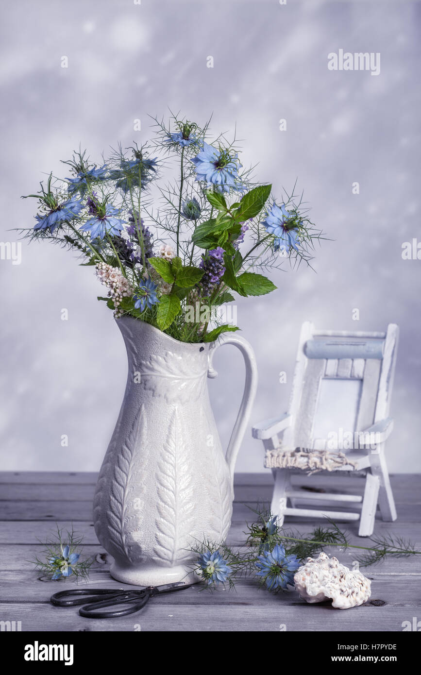 Antique jug filled with wild flowers Stock Photo - Alamy