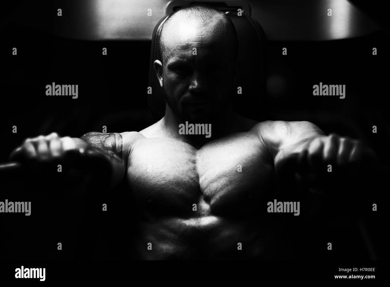 Big Man In The Gym Is Exercising Back On Machine - Muscular Athletic ...