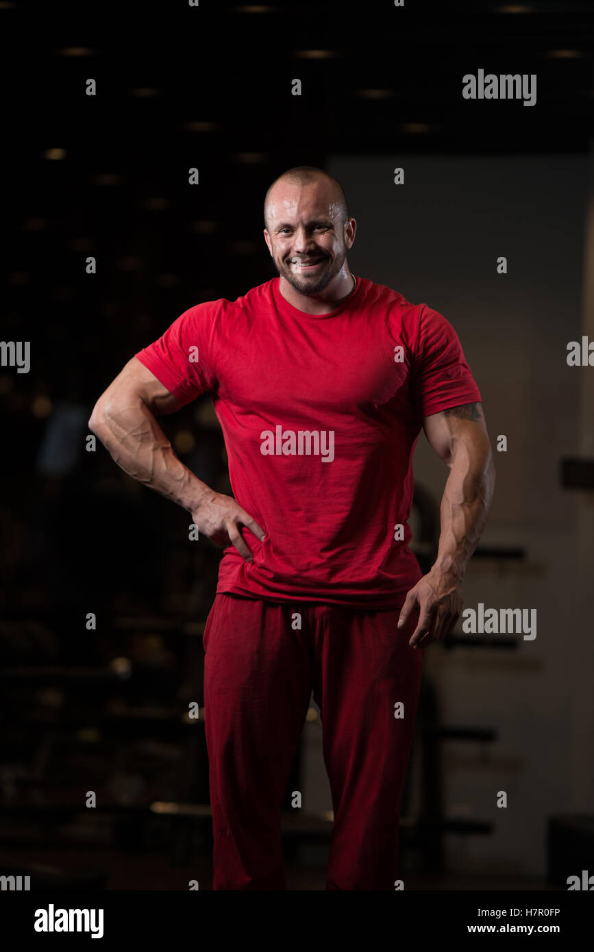 Man Standing Strong In The Gym And Flexing Muscles - Muscular Athletic ...