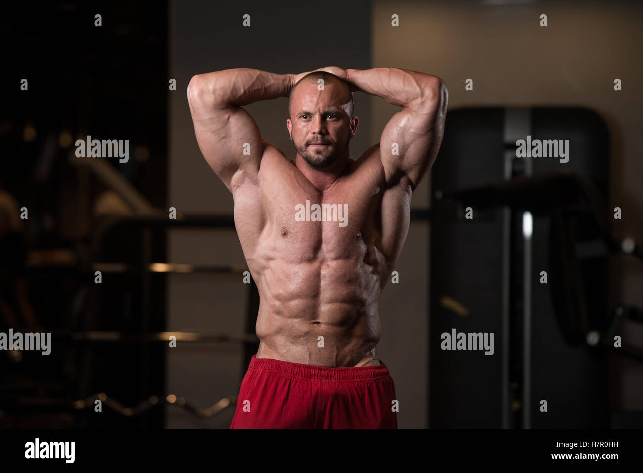 Man Standing Strong In The Gym And Flexing Muscles - Muscular Athletic ...