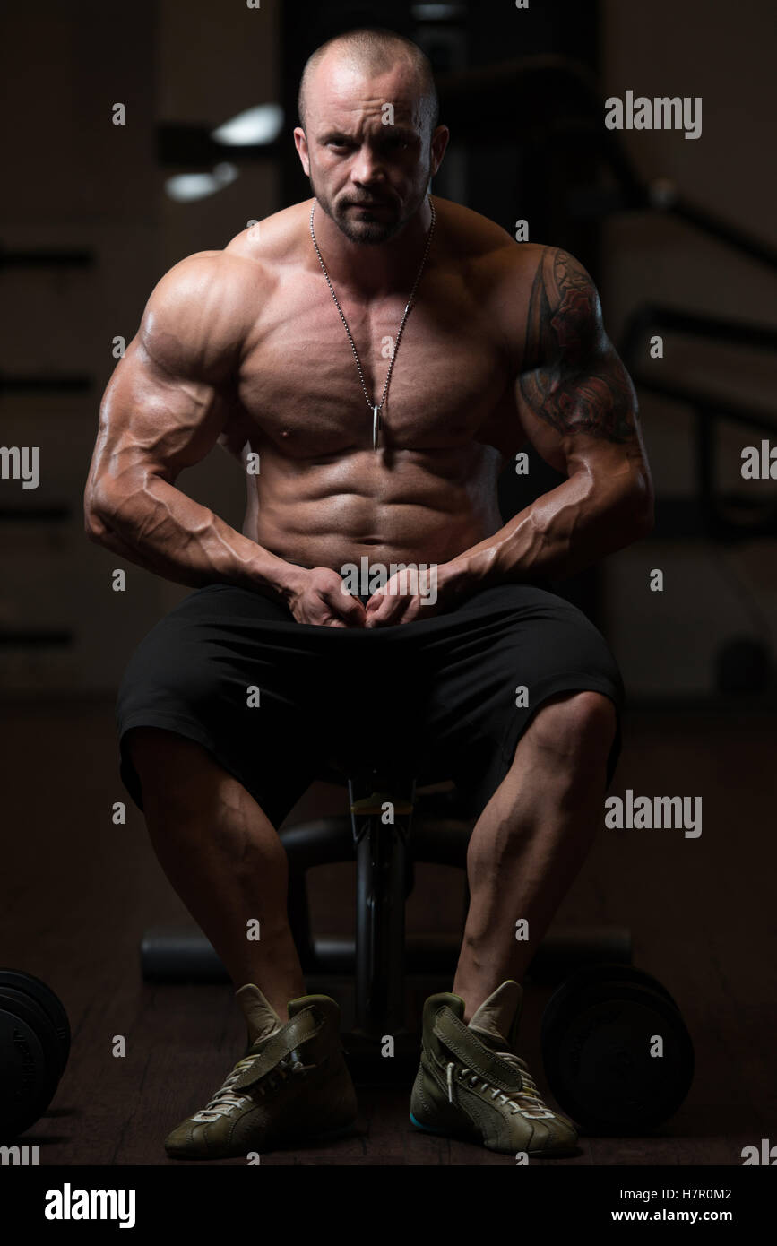 Man Standing Strong In The Gym And Flexing Muscles - Muscular Athletic ...