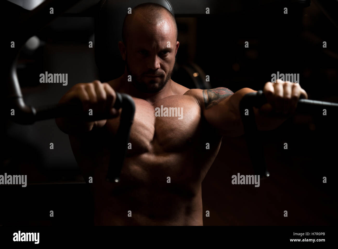 Big Man In The Gym Is Exercising Back On Machine - Muscular Athletic ...