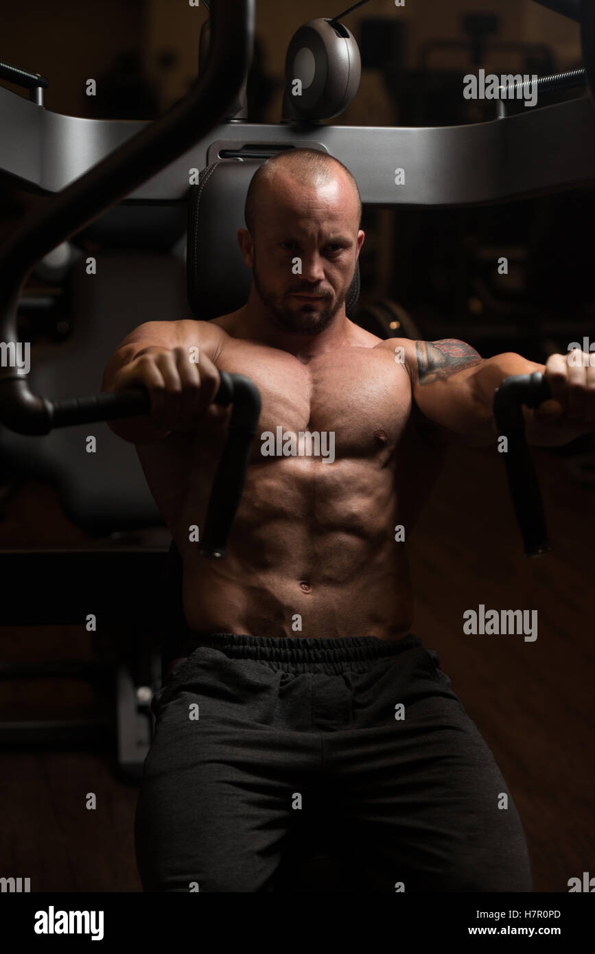 Big Man In The Gym Is Exercising Back On Machine - Muscular Athletic ...