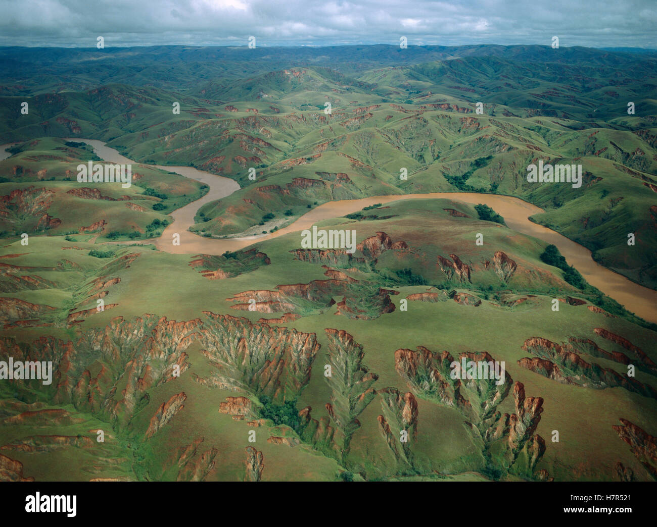 Deforested and deeply eroded hills alongside silted river, Betsiboka ...
