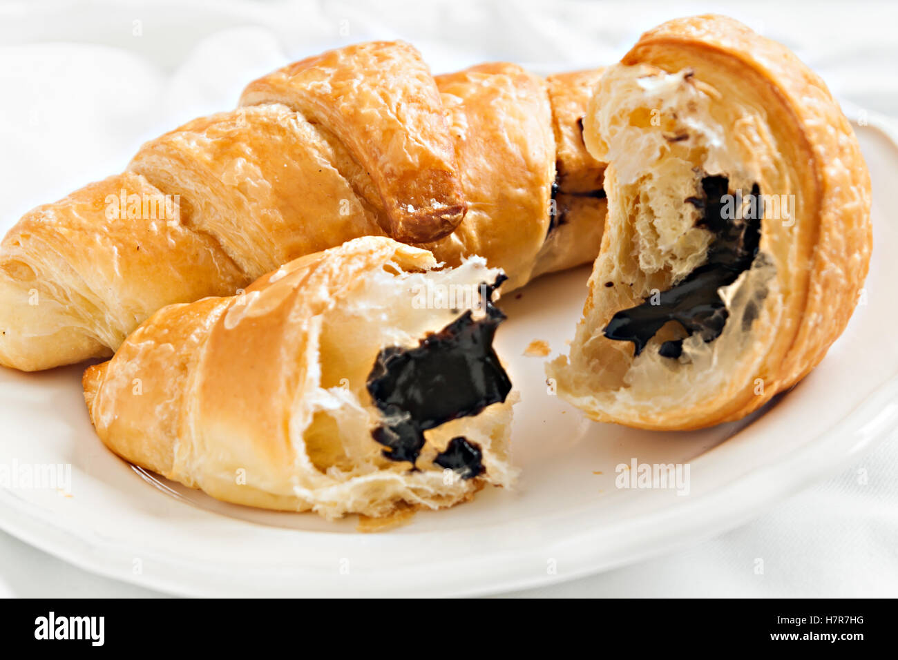 croissant with chocolate is broken close up Stock Photo - Alamy