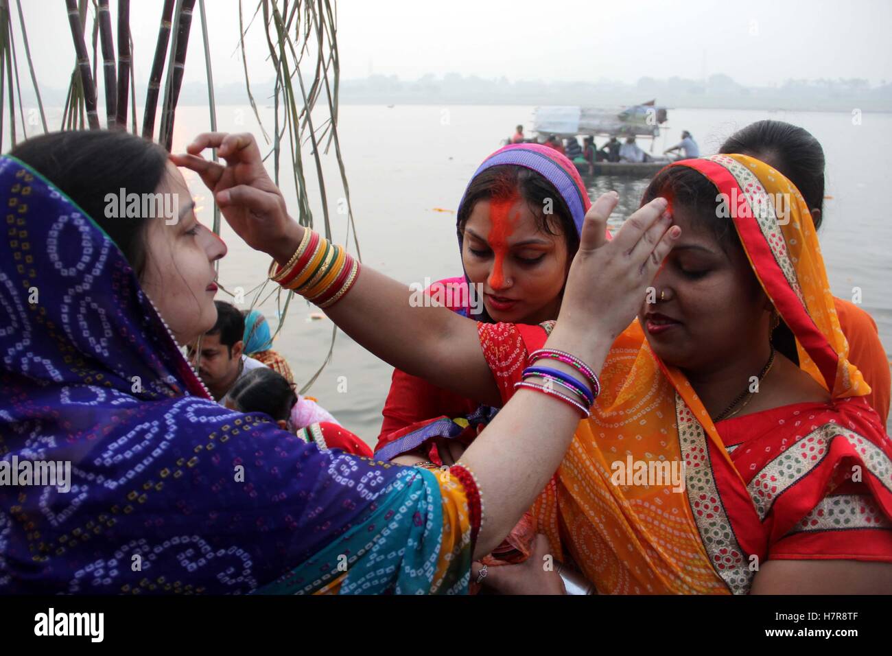 Hindu devotees offer prayers to Suraya Dev on rising sun in the waters ...