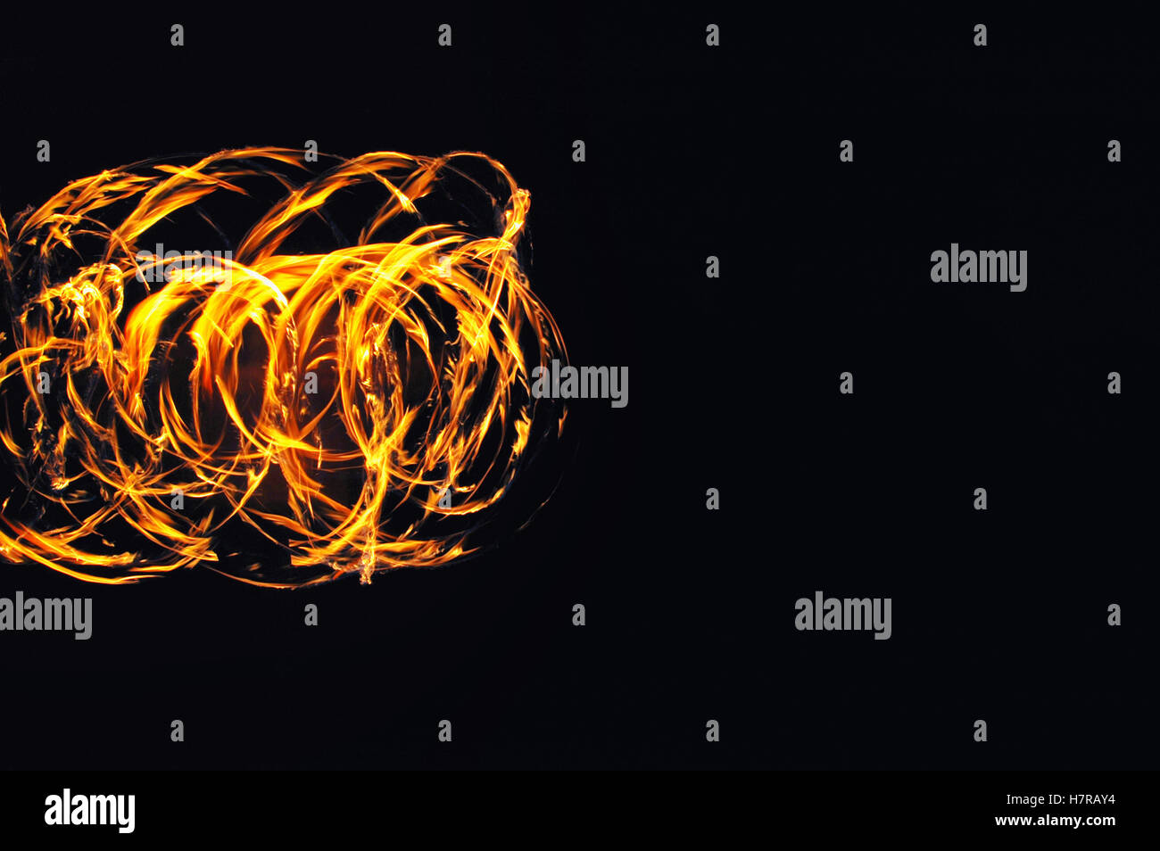 Spinning fire poi Stock Photo - Alamy