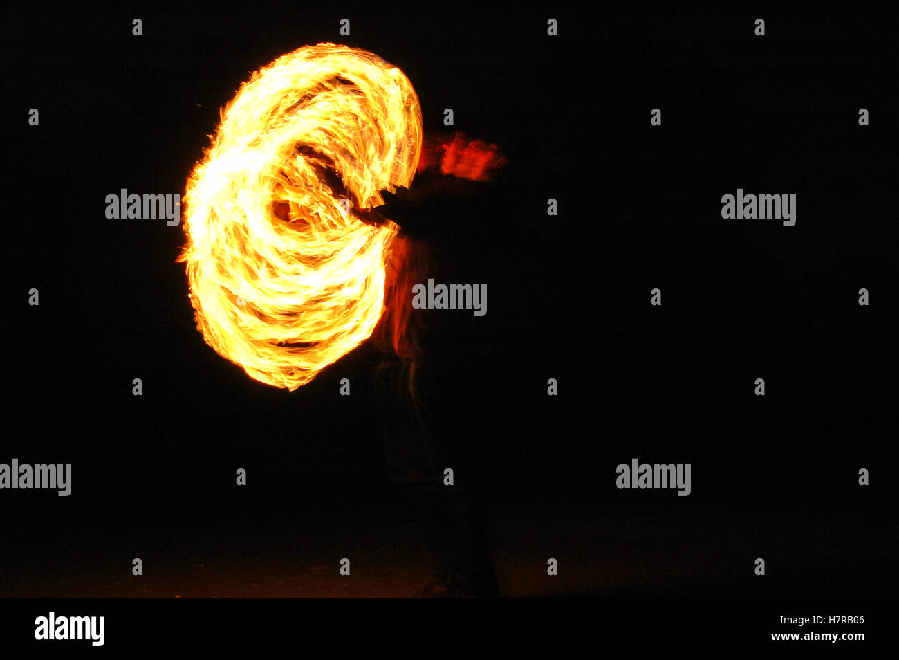 Spinning fire poi Stock Photo - Alamy