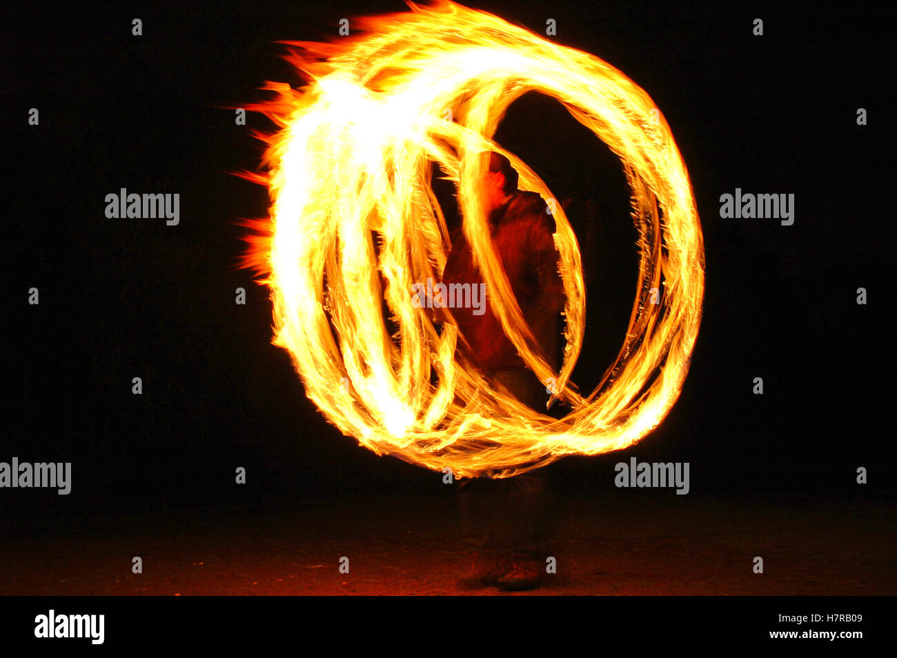 Spinning fire poi Stock Photo - Alamy