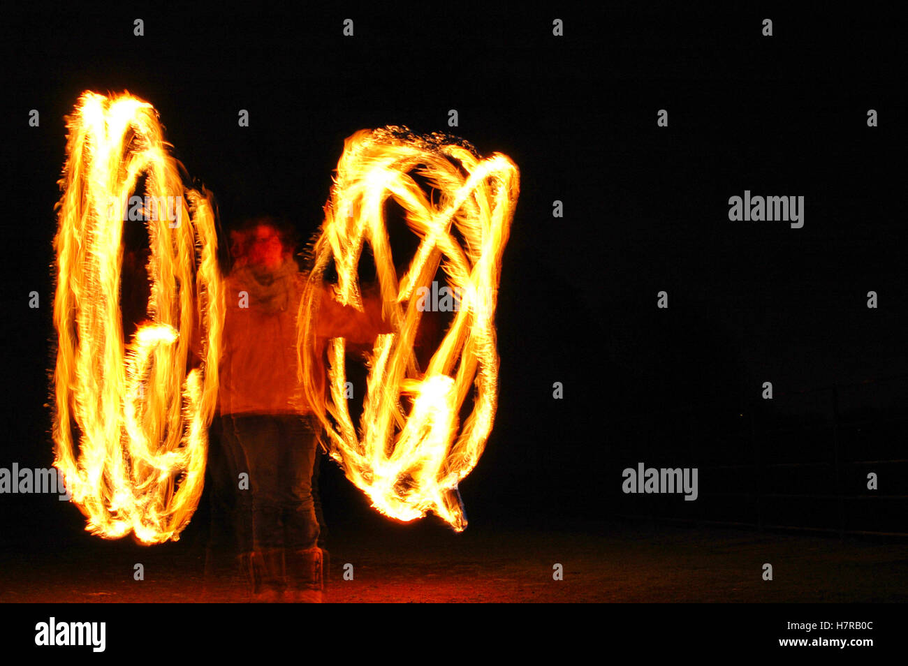 Spinning fire poi Stock Photo - Alamy