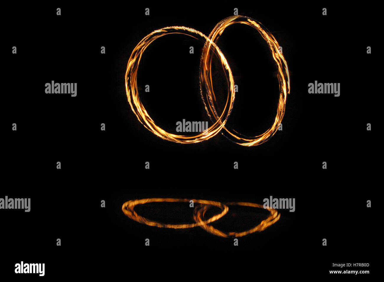 Spinning fire poi Stock Photo - Alamy