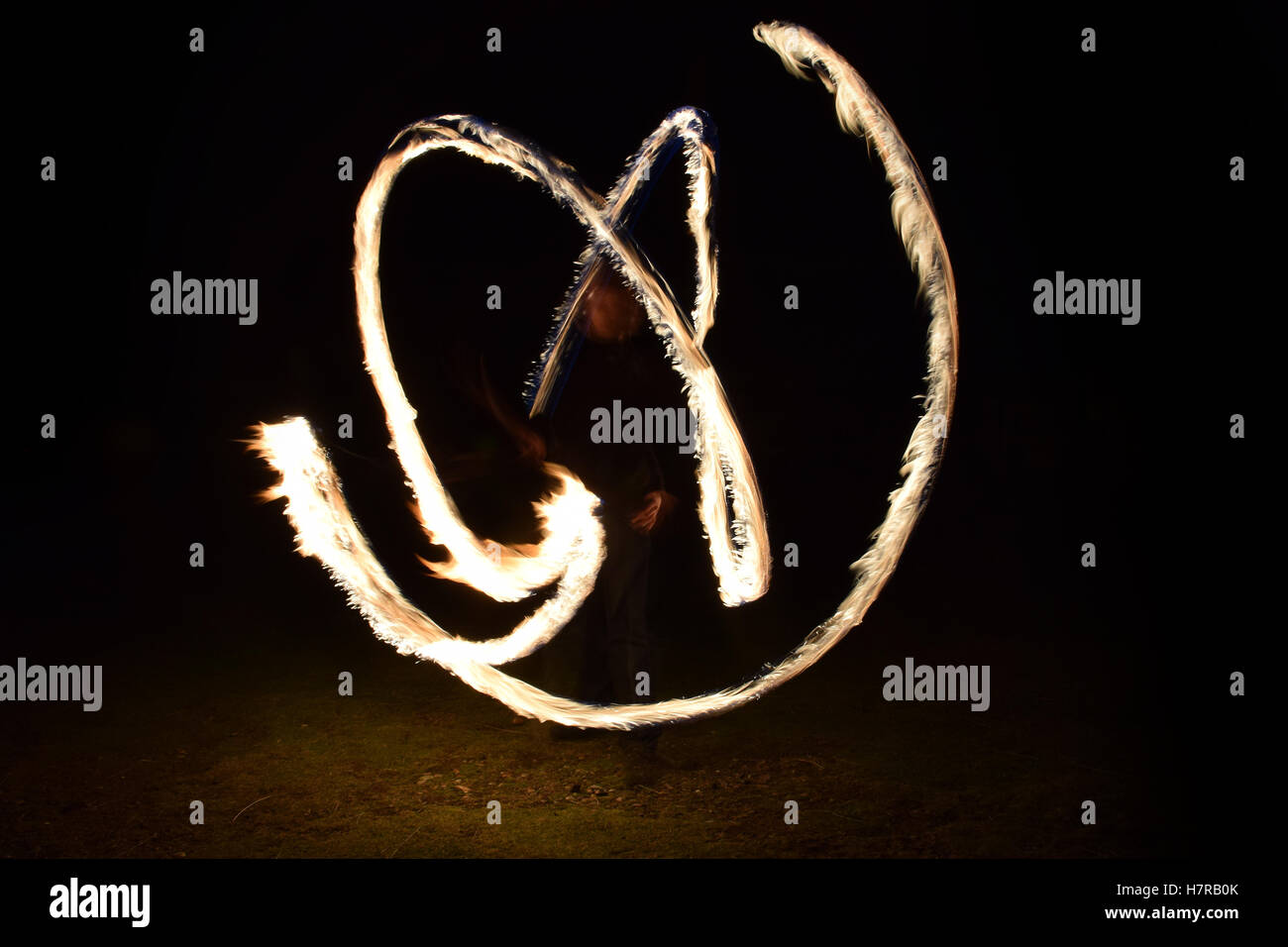 Spinning fire poi Stock Photo - Alamy