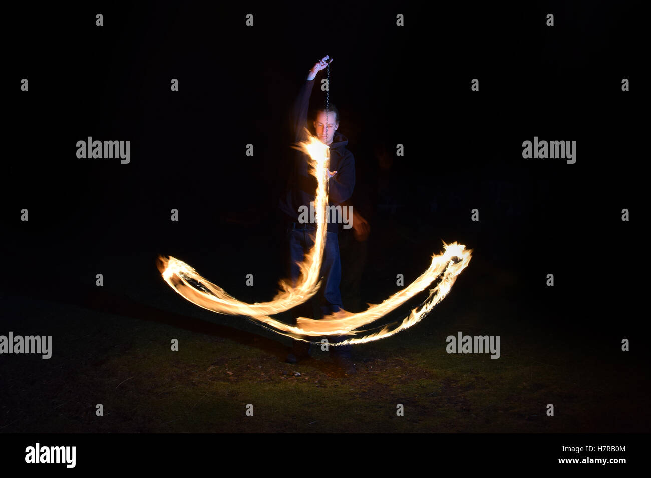 Spinning fire poi Stock Photo - Alamy