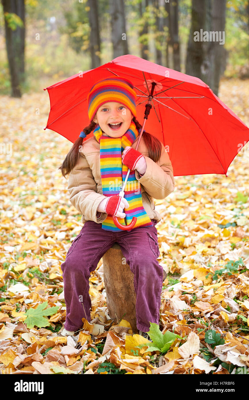 girl child in autumn forest with umbrella, beautiful landscape in fall ...