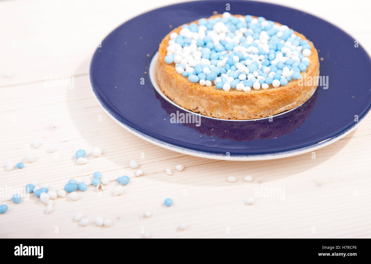 Traditional Dutch birth celebration biscuit with blue muisjes on wooden ...
