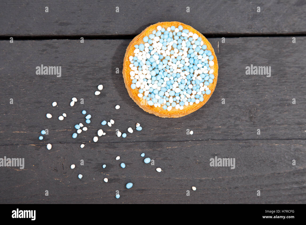 Traditional Dutch birth celebration biscuit with blue muisjes on wooden ...