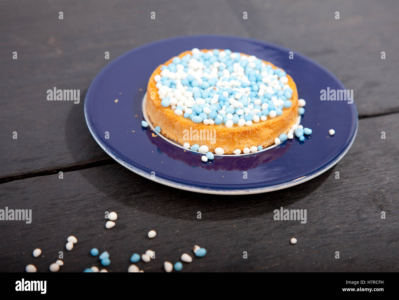 Traditional Dutch birth celebration biscuit with blue muisjes on wooden ...