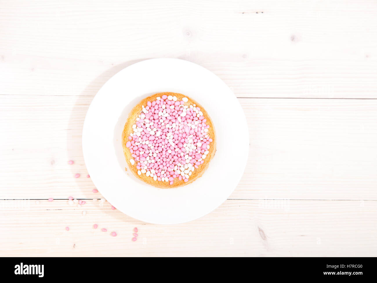 Traditional Dutch birth celebration biscuit with pink muisjes on wooden ...