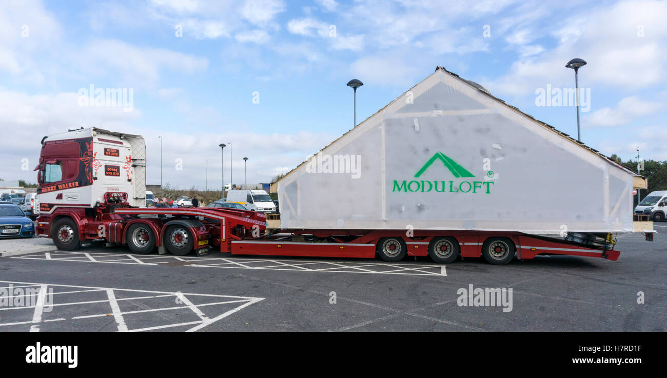 A Moduloft ready-made roof extension loaded on a low-loader lorry for ...