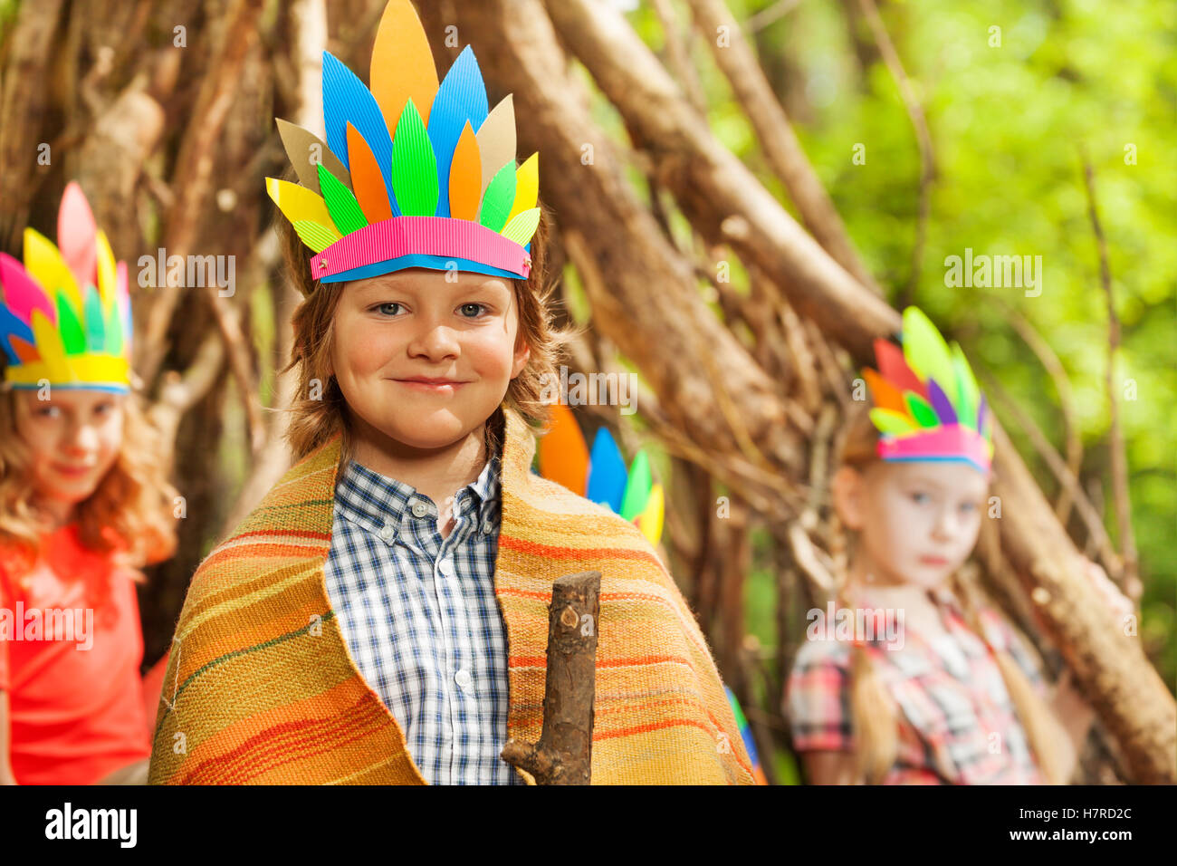 Happy boy in Injun's costume playing with friends Stock Photo - Alamy