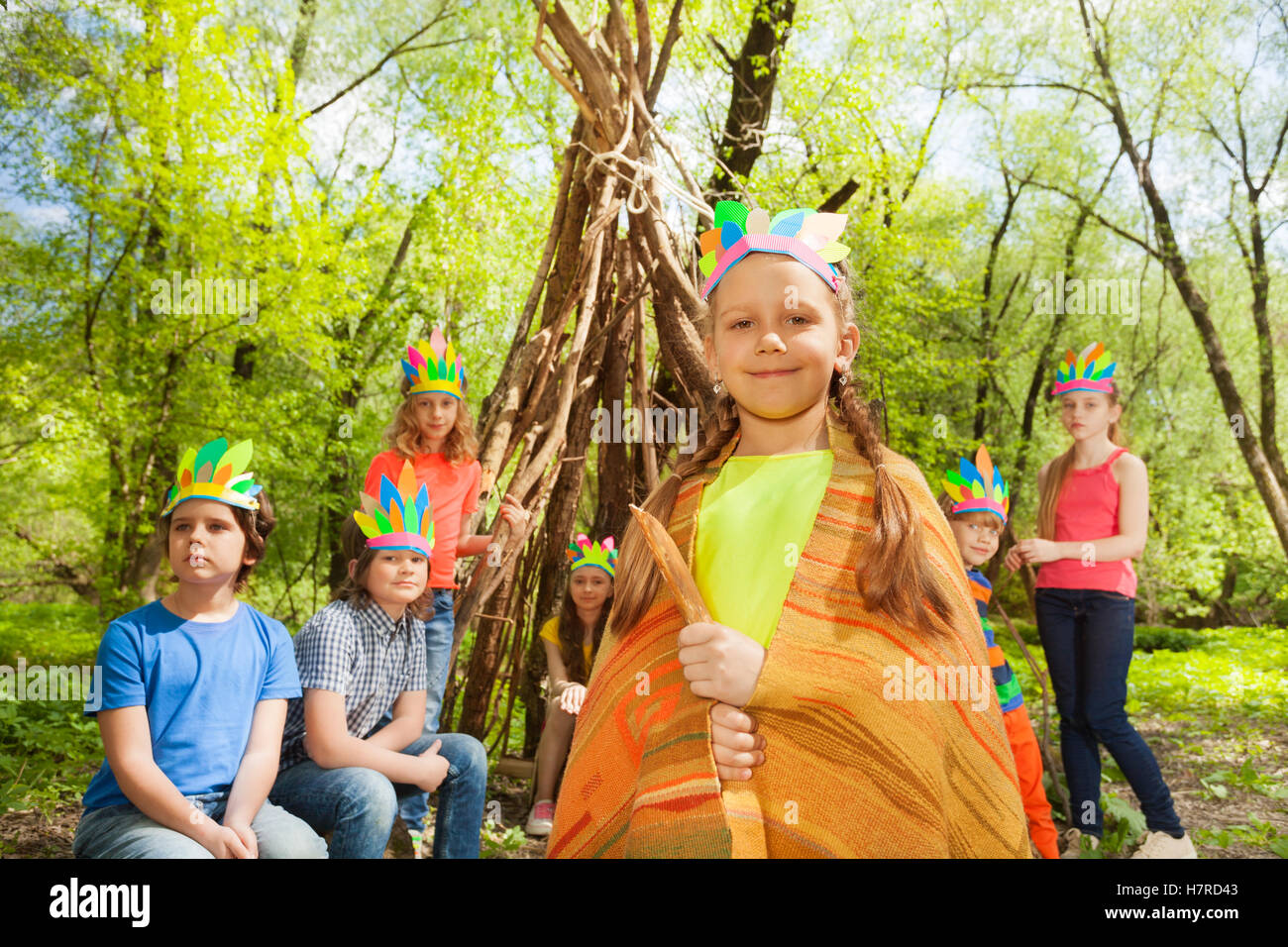 Happy girl playing Injuns with her friends Stock Photo - Alamy