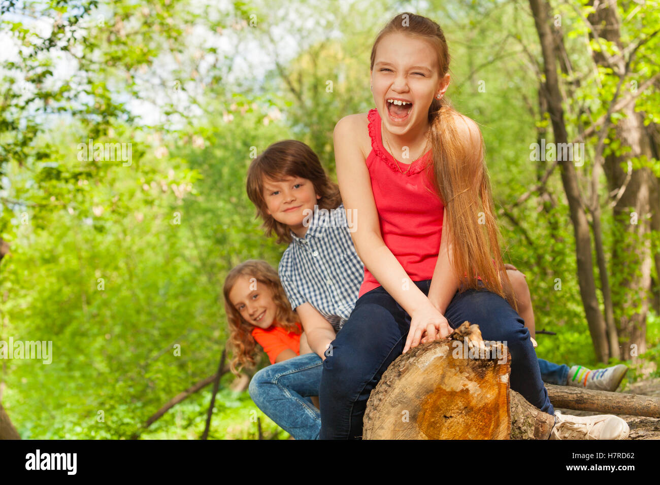 Smiling child sitting on log hi-res stock photography and images - Alamy