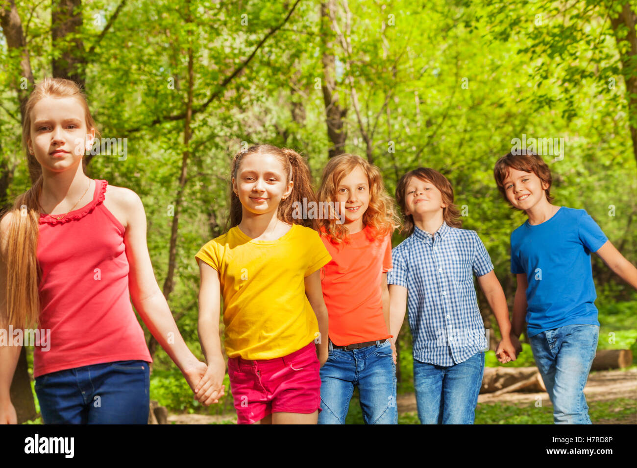Happy friends walking together in the summer park Stock Photo - Alamy