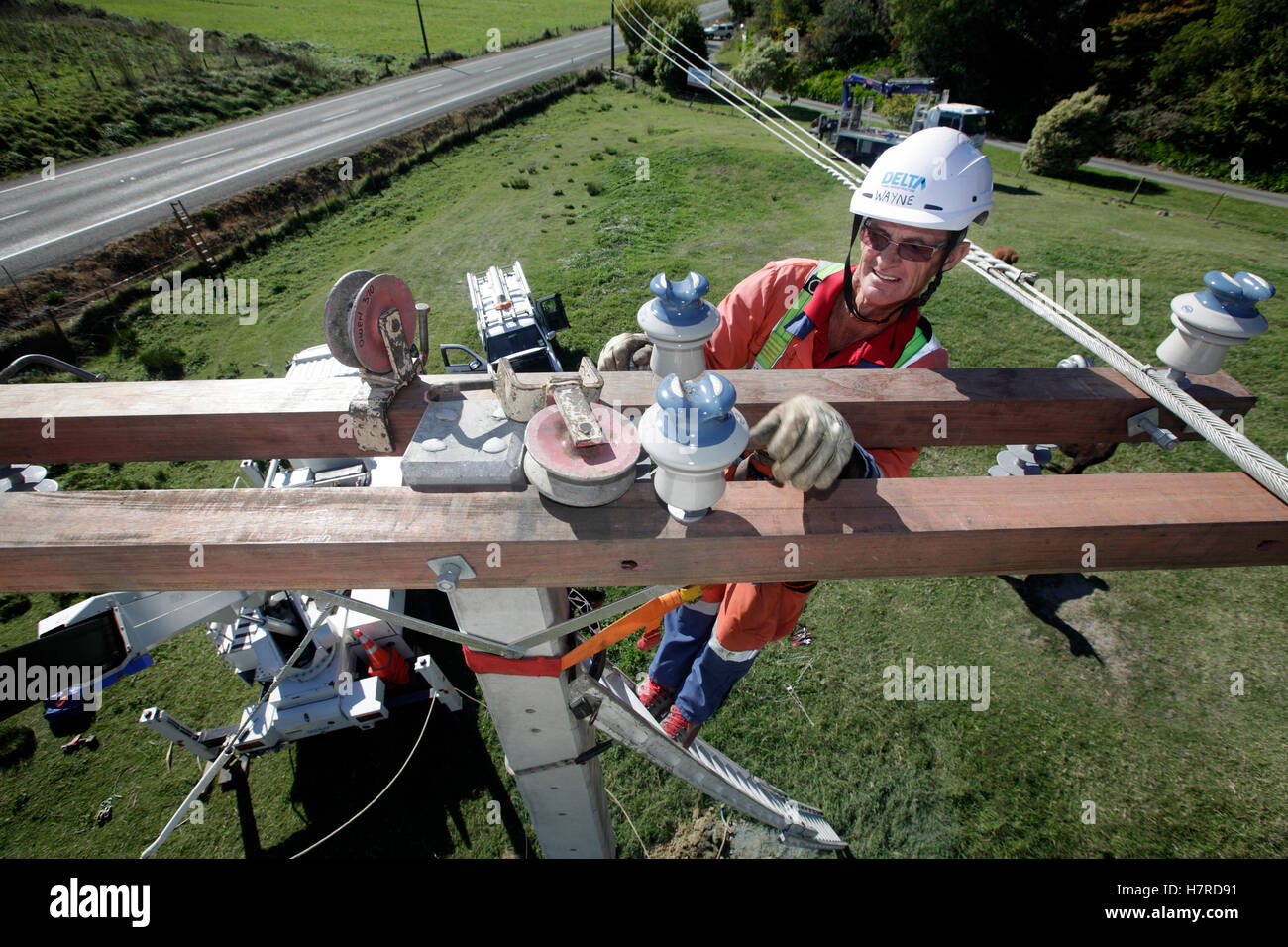 power company worker on ladder replacing high voltage power cables ...