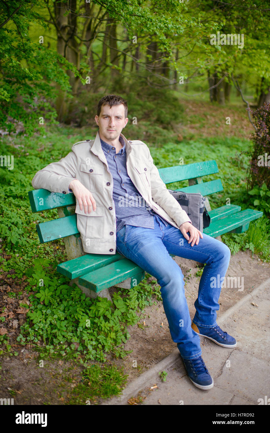 man sitting on bench in the park in spring time Stock Photo - Alamy