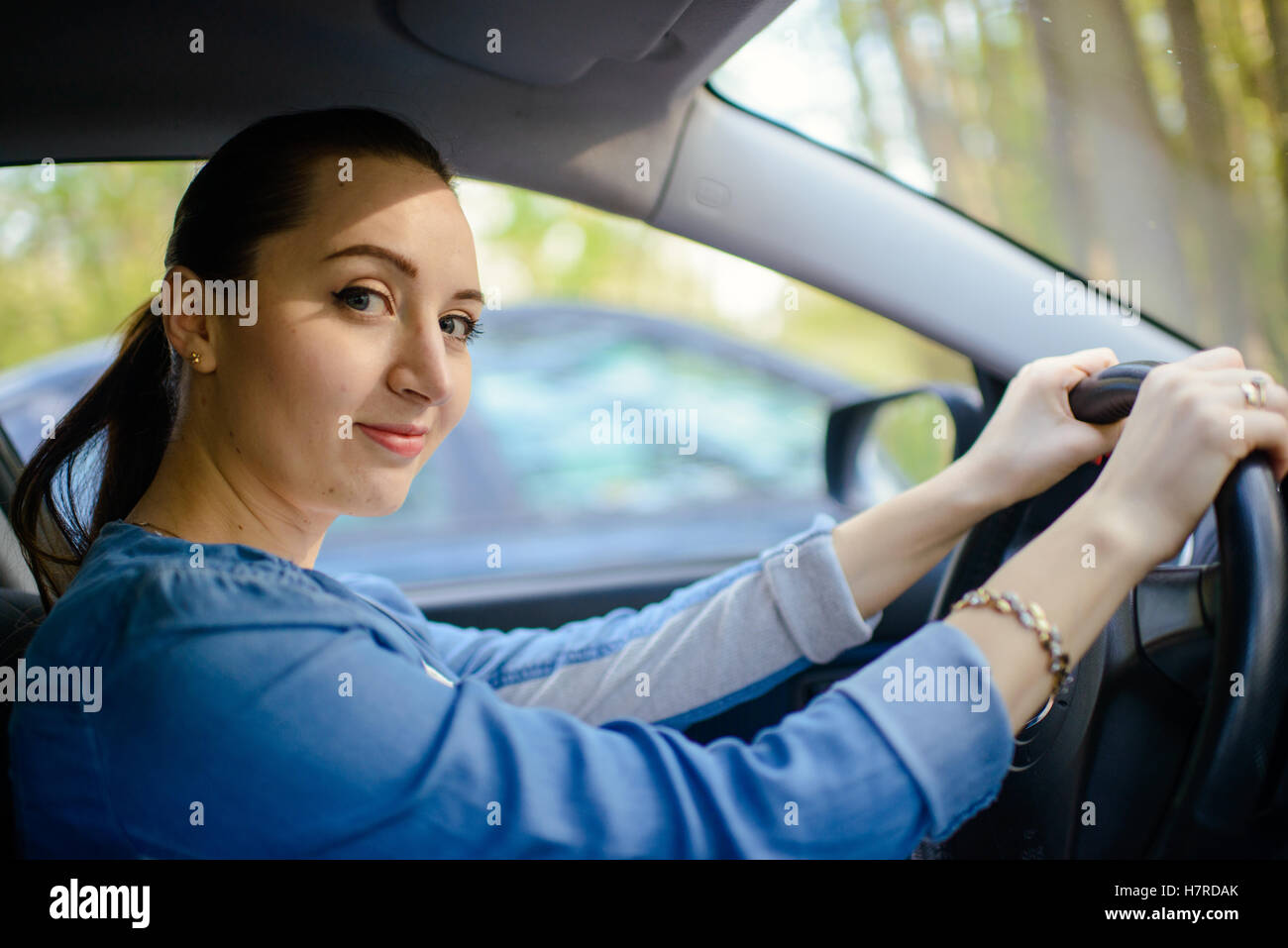 Female hands over a wheel in the car, close up Stock Photo - Alamy