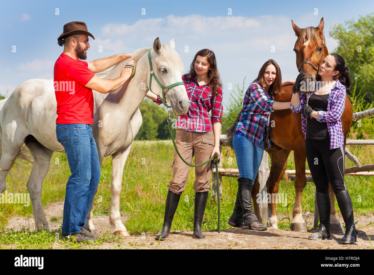 Portrait of four horseback riders with horses Stock Photo - Alamy