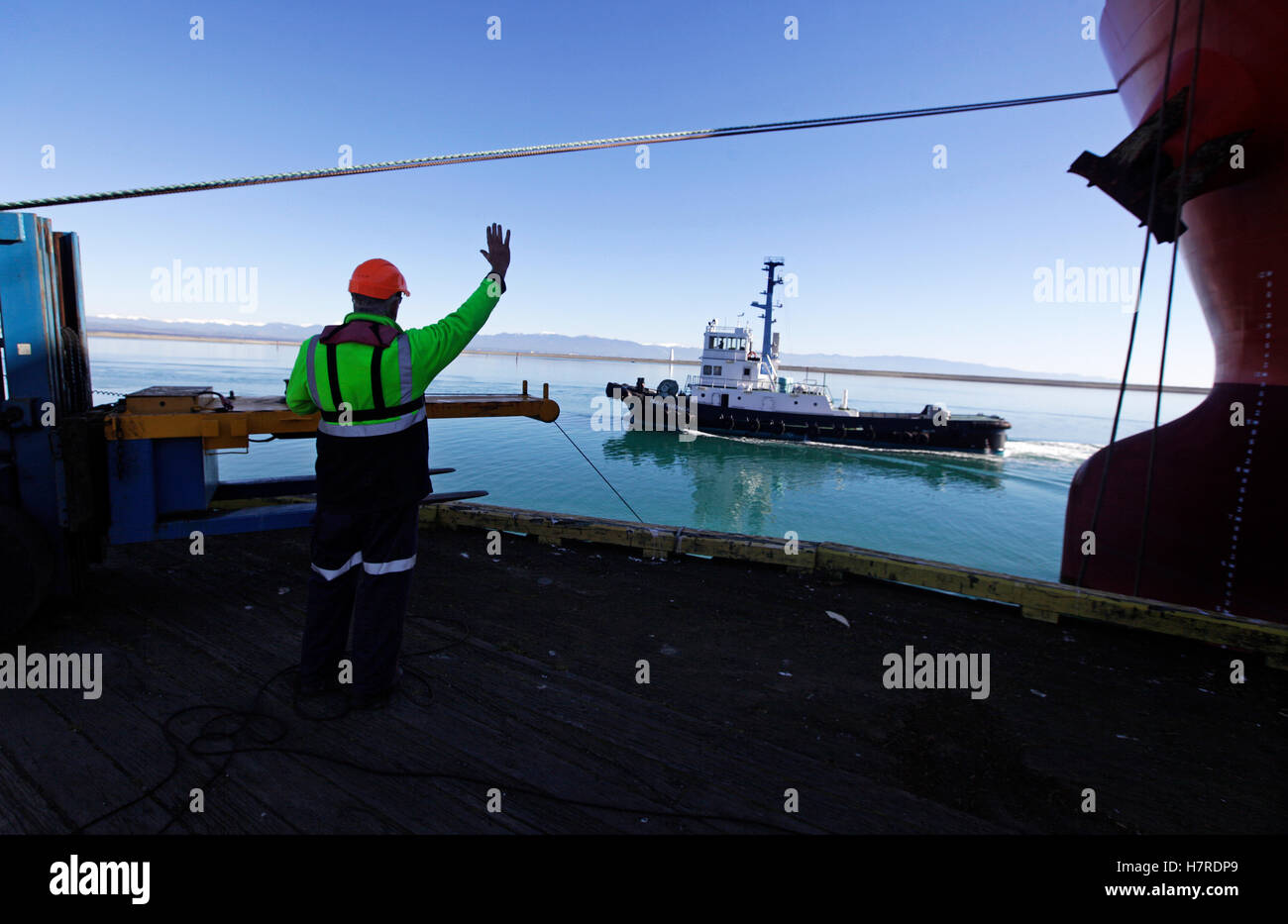 A stevedore waves to the Port Nelson tug Huria Matenga after bringing a ...