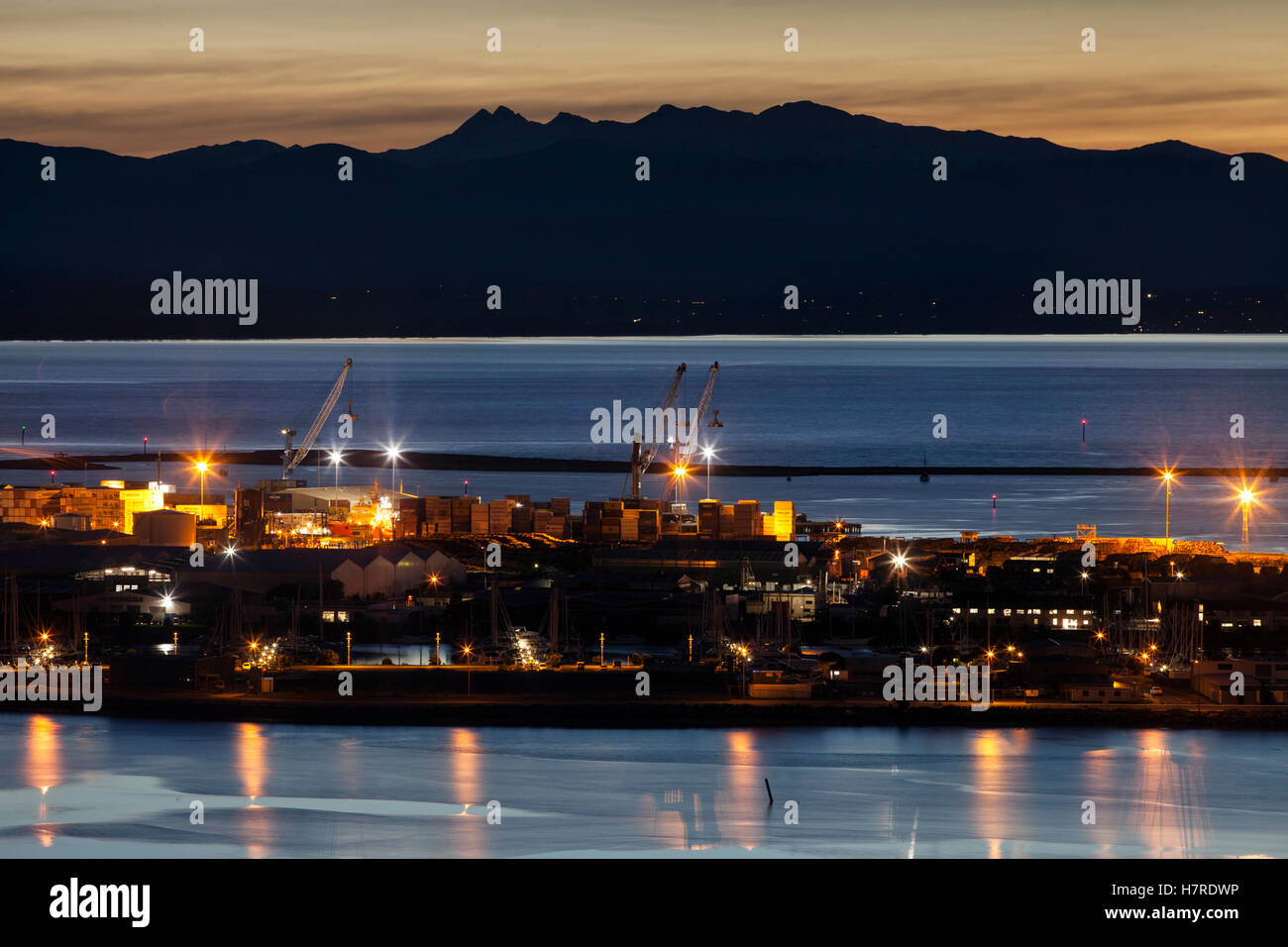 Dusk view of Port Nelson with the Mount Arthur range of mountains in ...