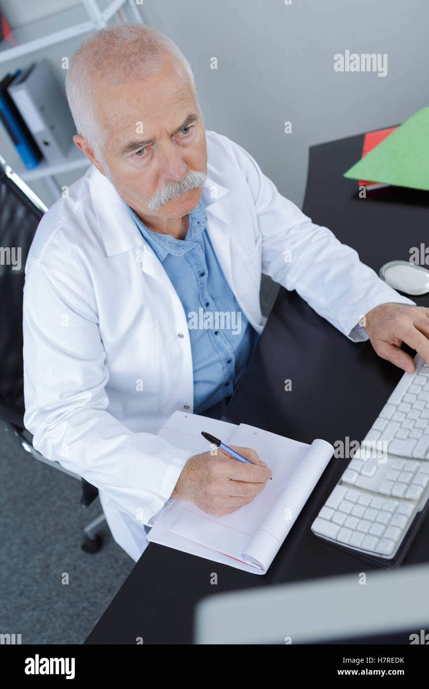 male doctor using a computer Stock Photo - Alamy