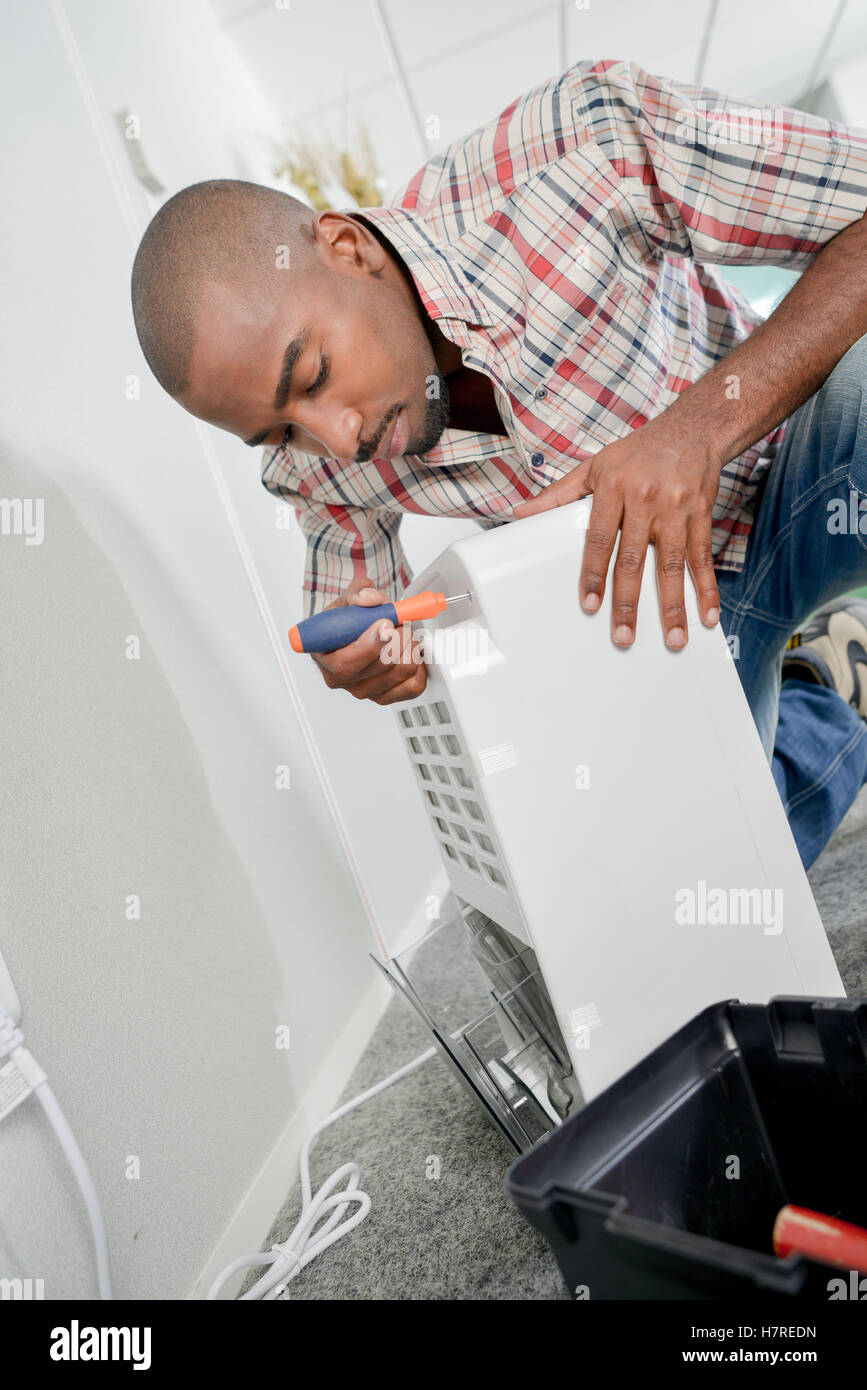 man fixing unit Stock Photo - Alamy