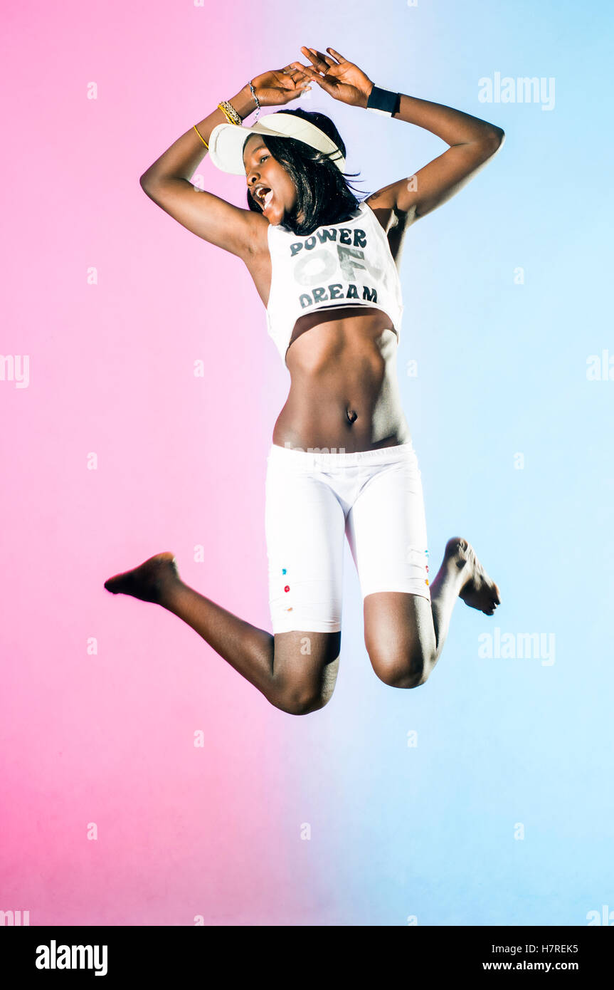 Young African woman jumping Stock Photo - Alamy