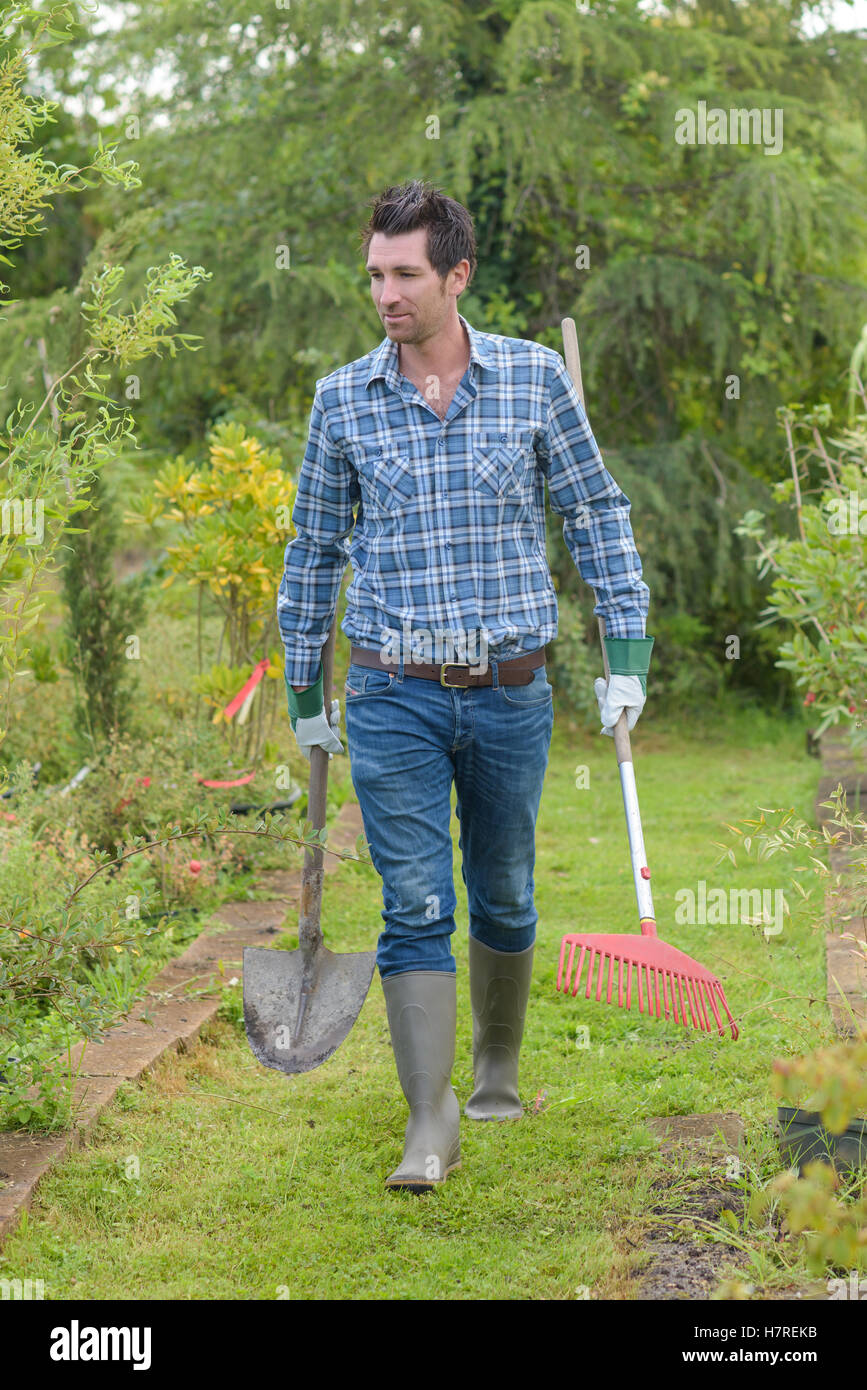 bringing spade and rake Stock Photo - Alamy
