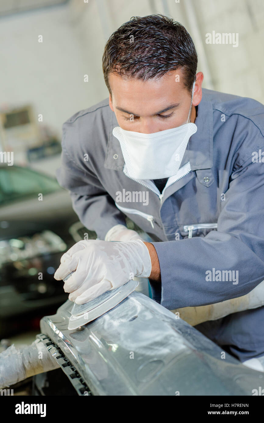 Mechanic using polishing machine Stock Photo - Alamy