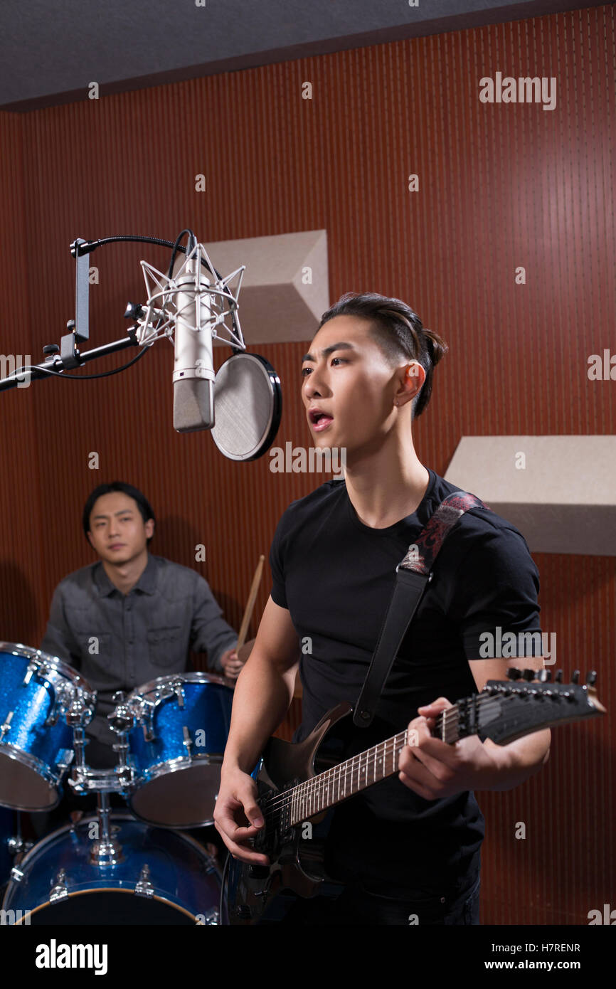 Chinese musical band in recording studio Stock Photo - Alamy