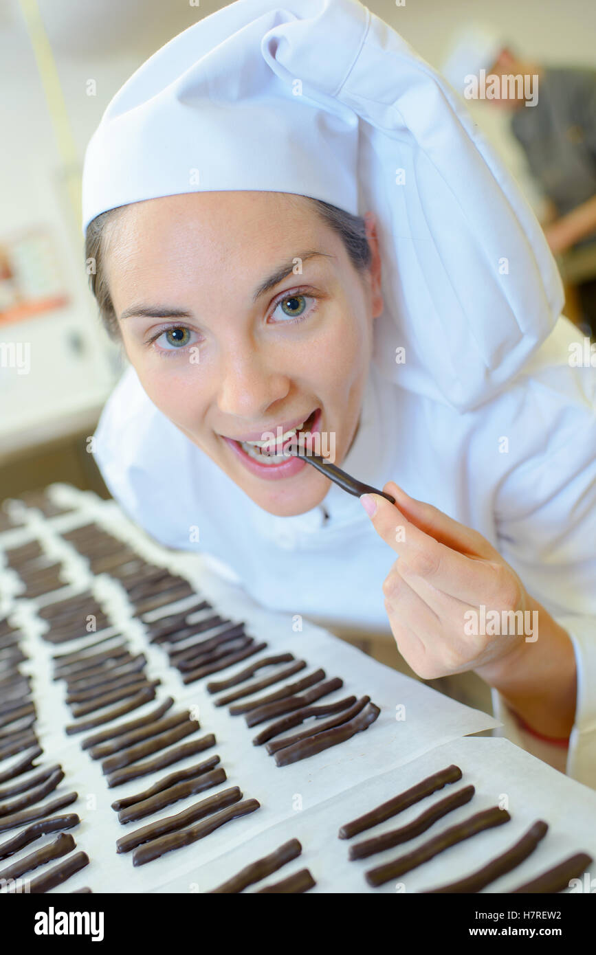 Chef eating chocolate sticks Stock Photo - Alamy