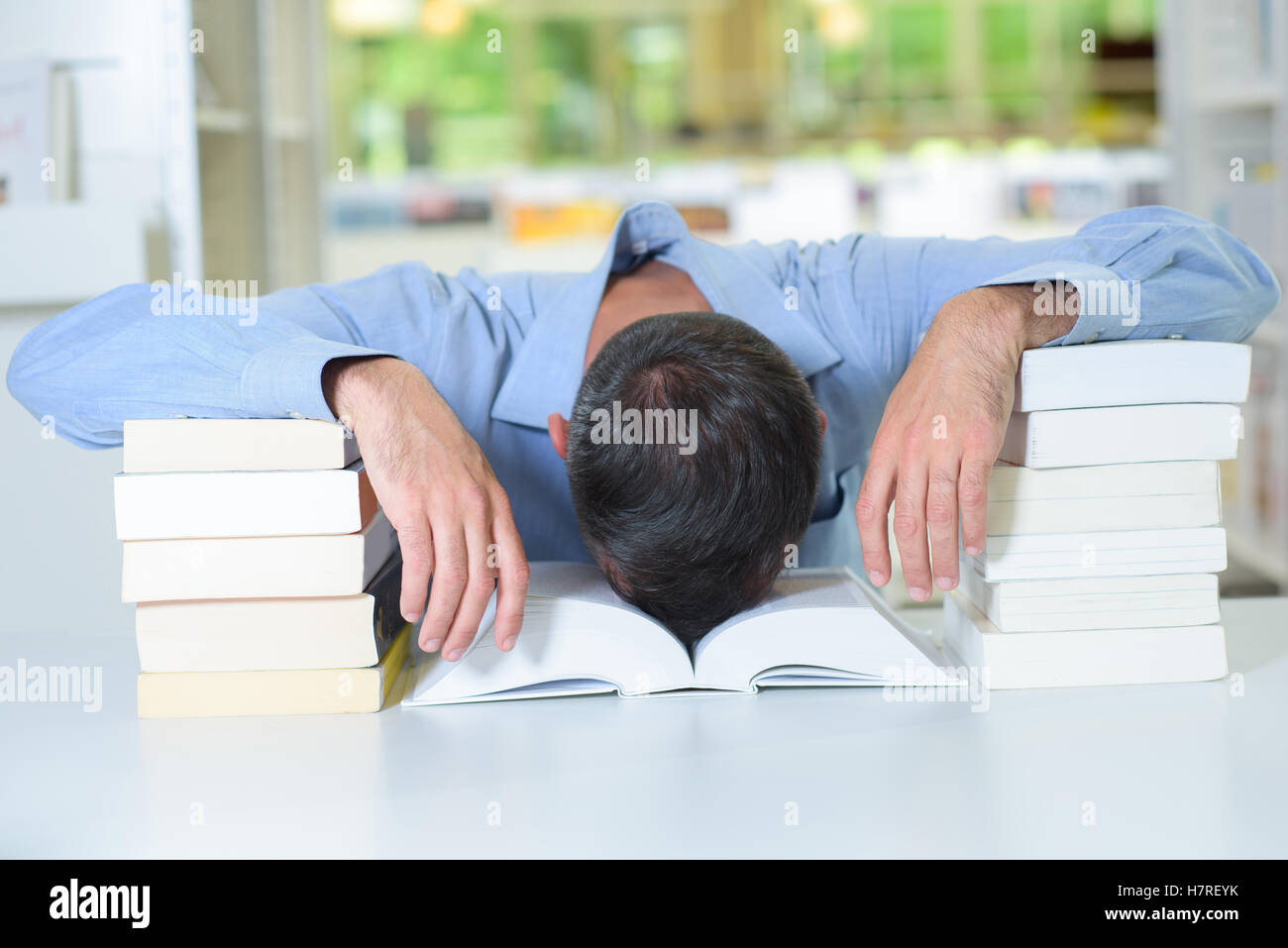 Slumped at table hi-res stock photography and images - Alamy