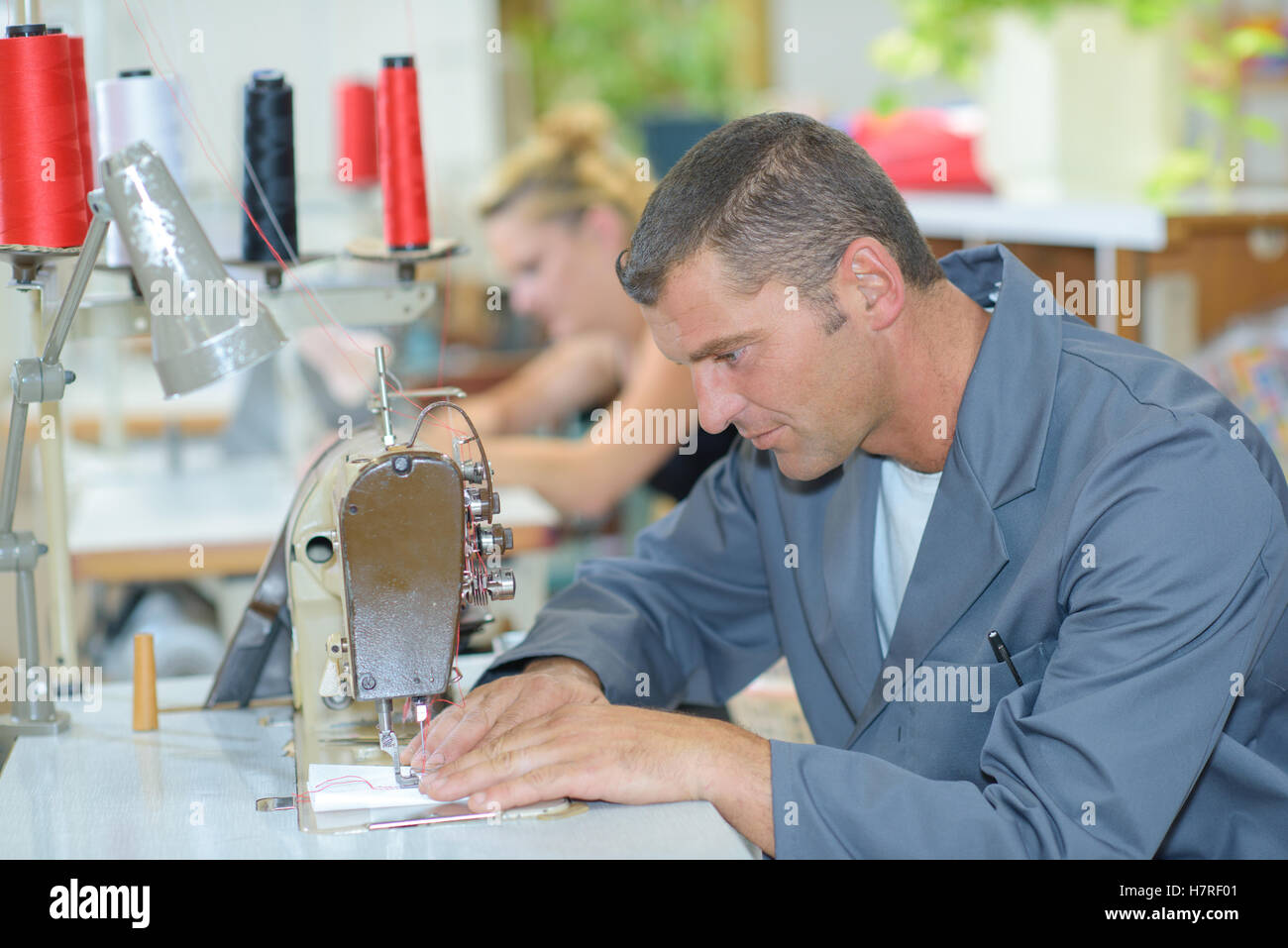 Man using sewing machine Stock Photo - Alamy